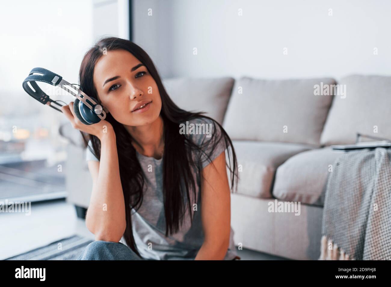 Young beautiful woman in casual clothes sitting at home alone and ...