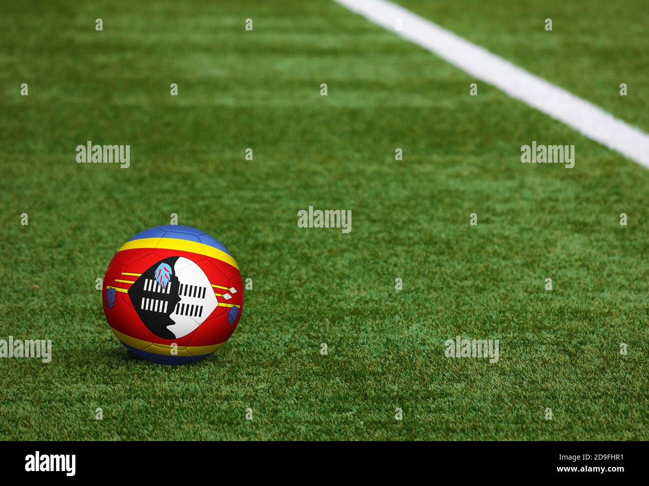 Swaziland flag on ball at soccer field background. National football ...