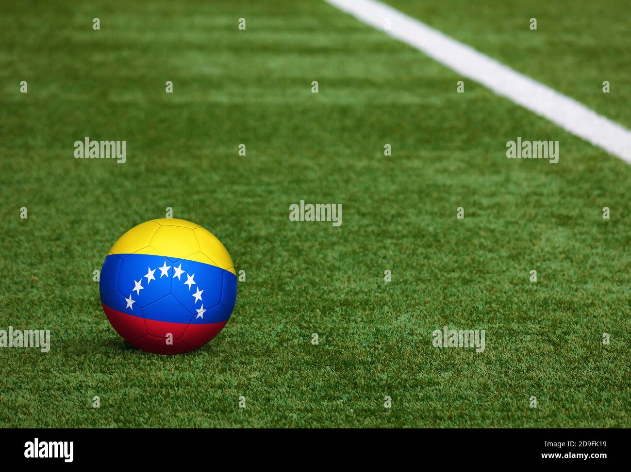 Venezuela flag on ball at soccer field background. National football ...