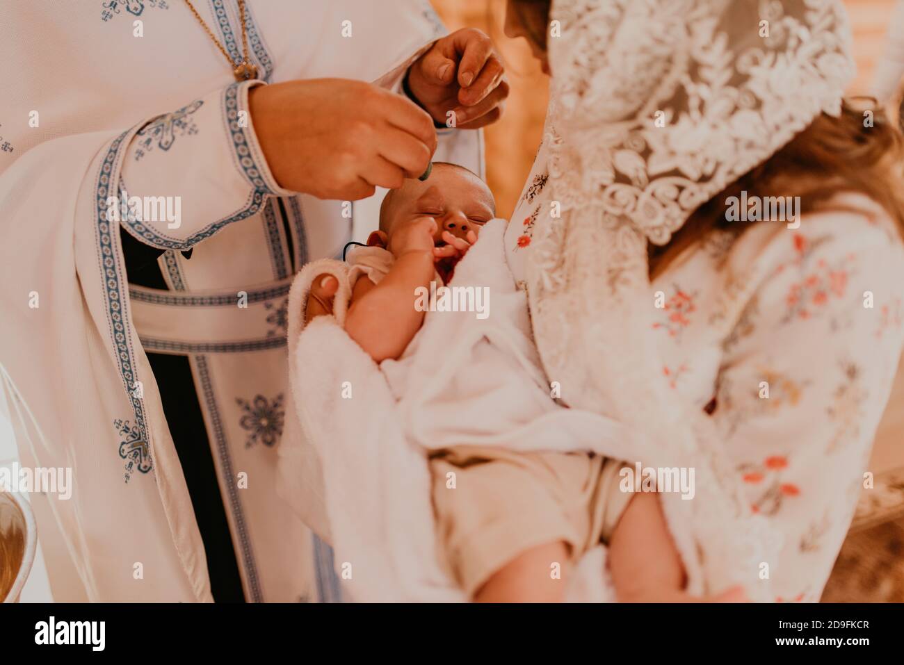 Priest blessing baby hi-res stock photography and images - Alamy