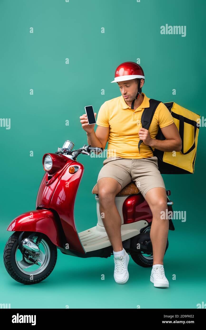 sad delivery man with backpack holding smartphone with blank screen ...
