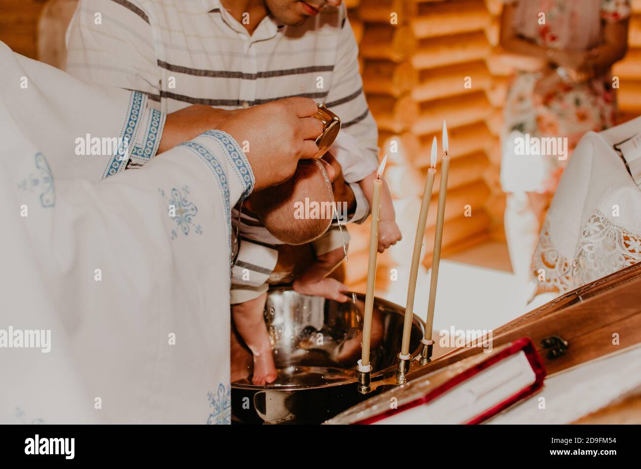 priest washes child with Sacred water. rite of sacrament of epiphany ...