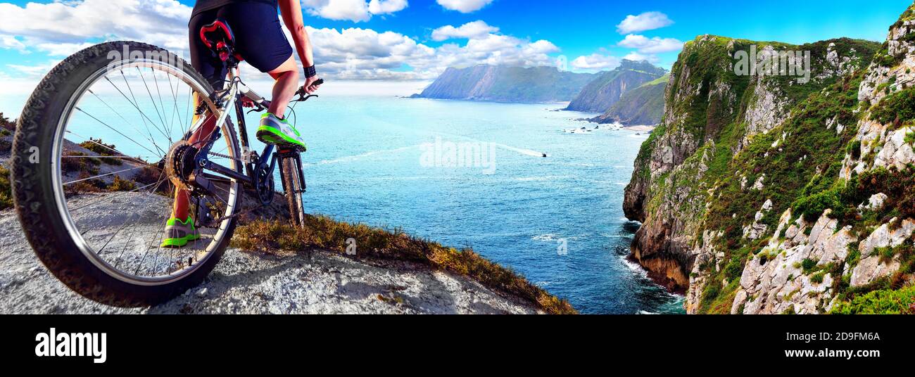 Exercise and healthy lifestyle. Biker and scenic cliff landscape ...