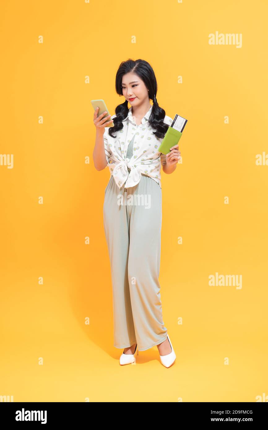 Image of successful voyage girl 20s expressing delight while holding ...