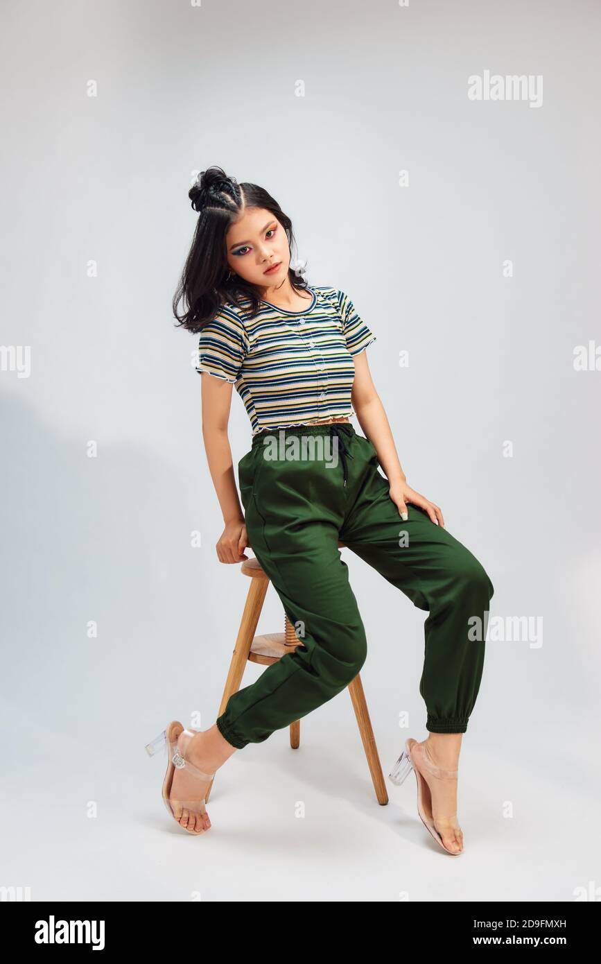 beautiful girl, hair flying in the wind sitting on a chair , smiling ...