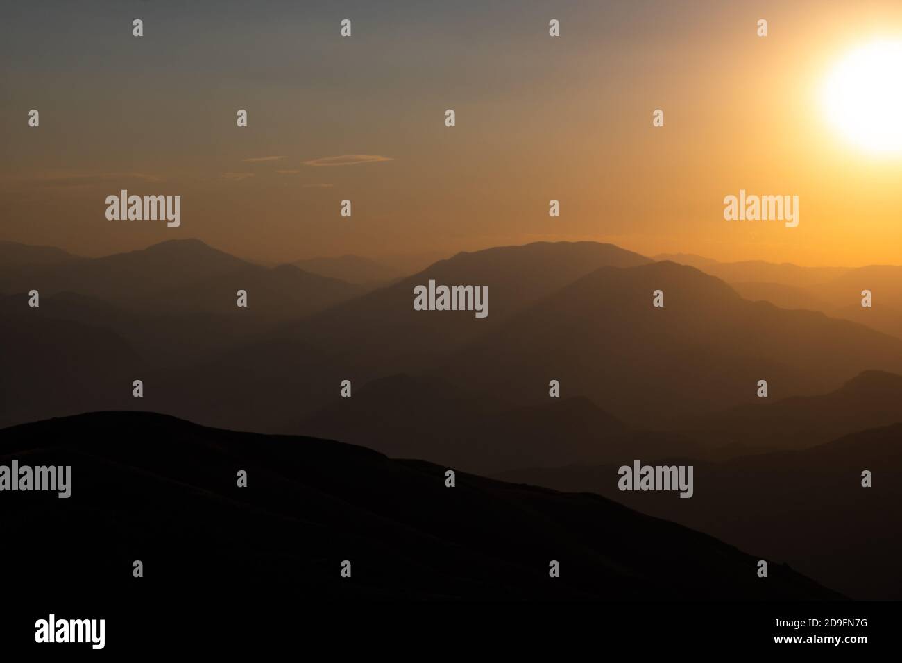 Sunset over the hills with beautiful scene of mountains Stock Photo - Alamy
