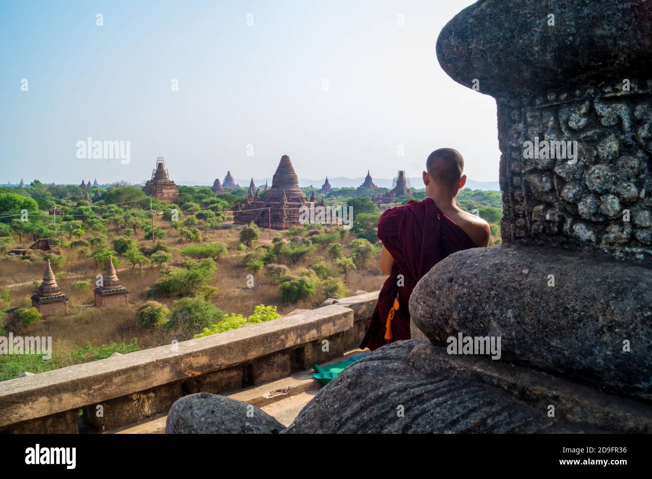 monk overseeing landscape with temples Stock Photo - Alamy