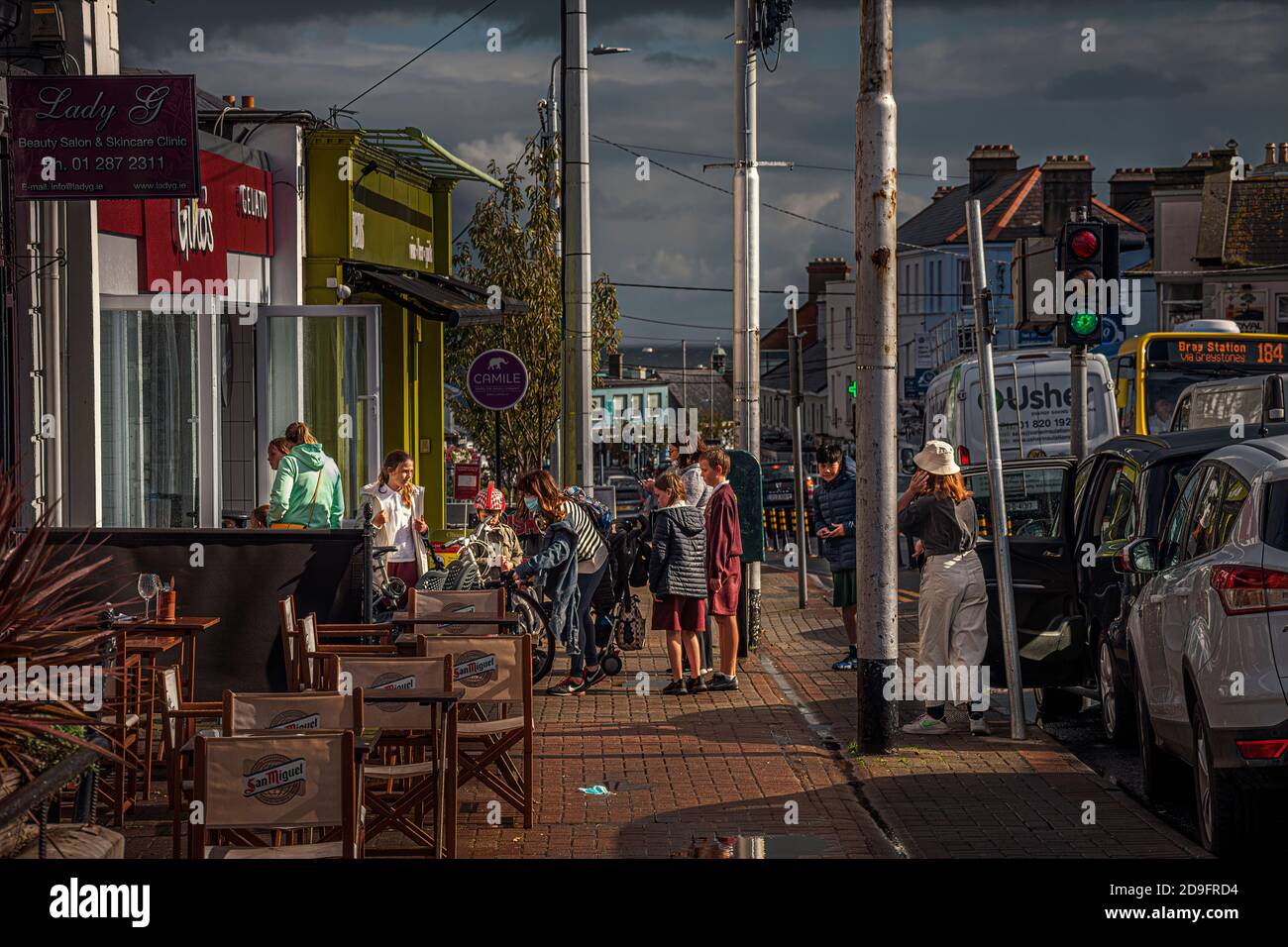 Everyday life. People queuing to local pizzeria at Main Street in ...