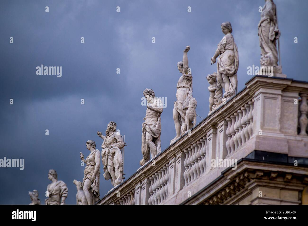 Rain clouds and roof statues Stock Photo - Alamy