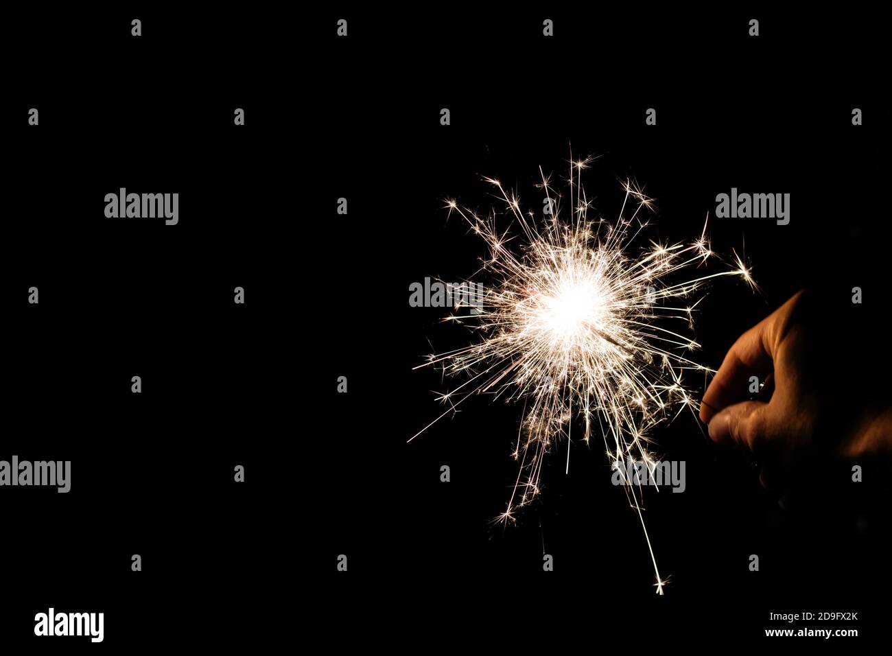 Bright sparkler light in the dark closeup Stock Photo - Alamy