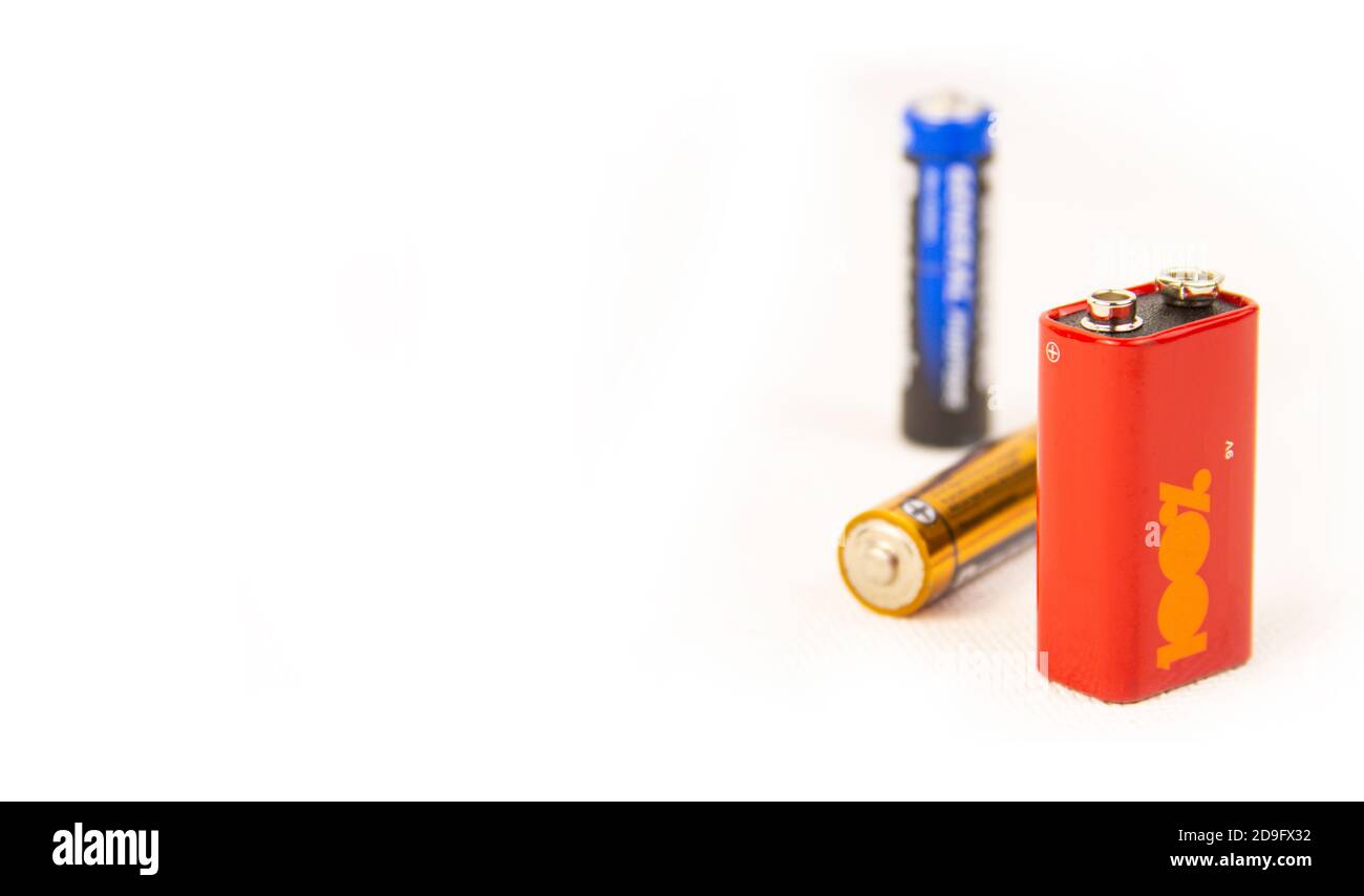 three different colors and sizes of batteries on a white background ...