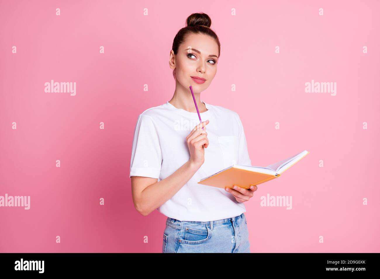 Photo of curious smart girl write copybook touch chin pencil look ...