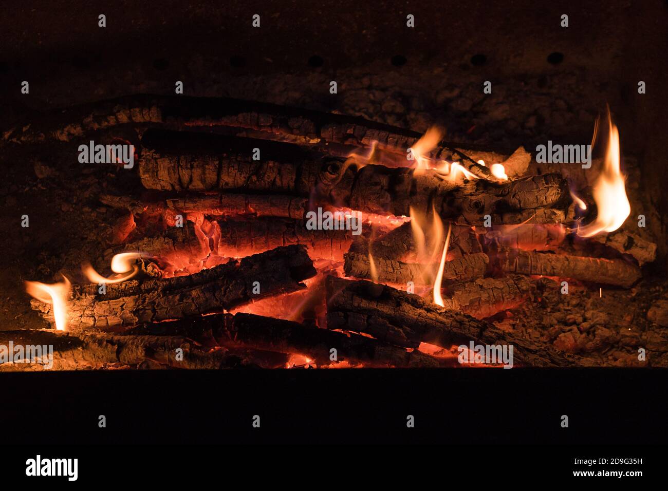 Fire in a fireplace from conflagrant wooden logs. Burning logs in a ...