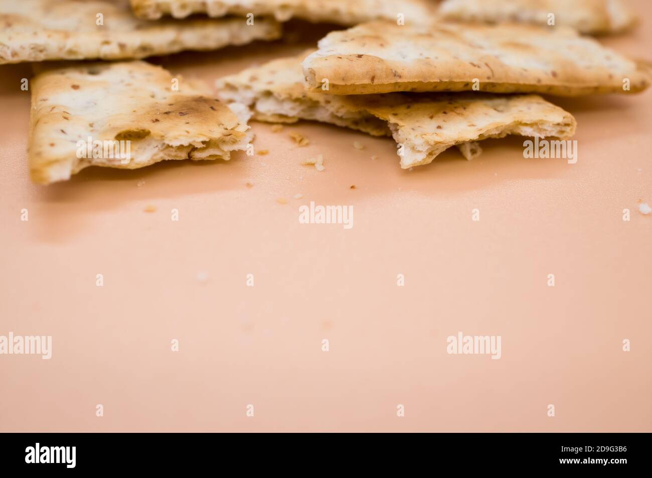 Closeup shot of the delicious crispy cracked crackers on the orange ...