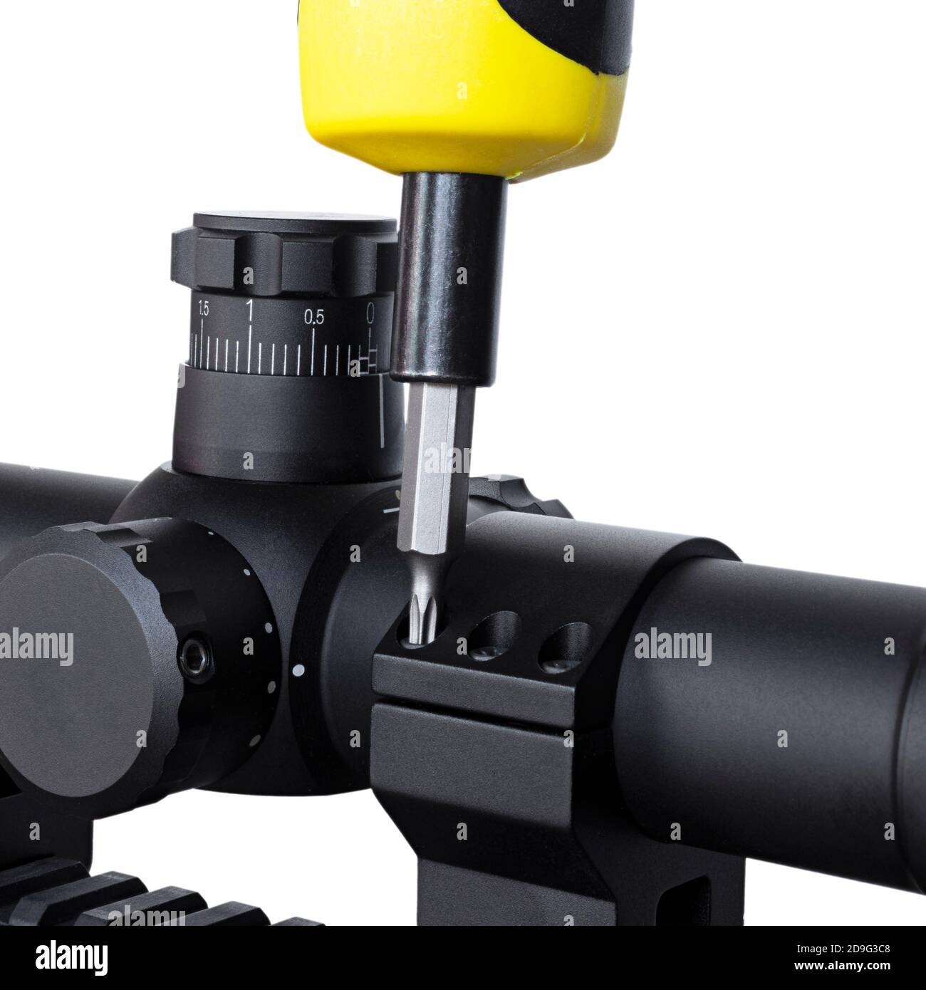 Yellow wrench being used to tighten the scope rings on a gun's optic ...