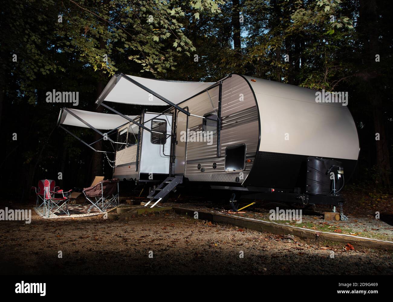 Travel trailer in early autumn set up at a campsite at Falls Lake North ...