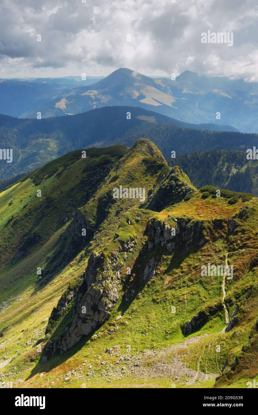 Summer landscape with steep mountains and sky with clouds Stock Photo ...
