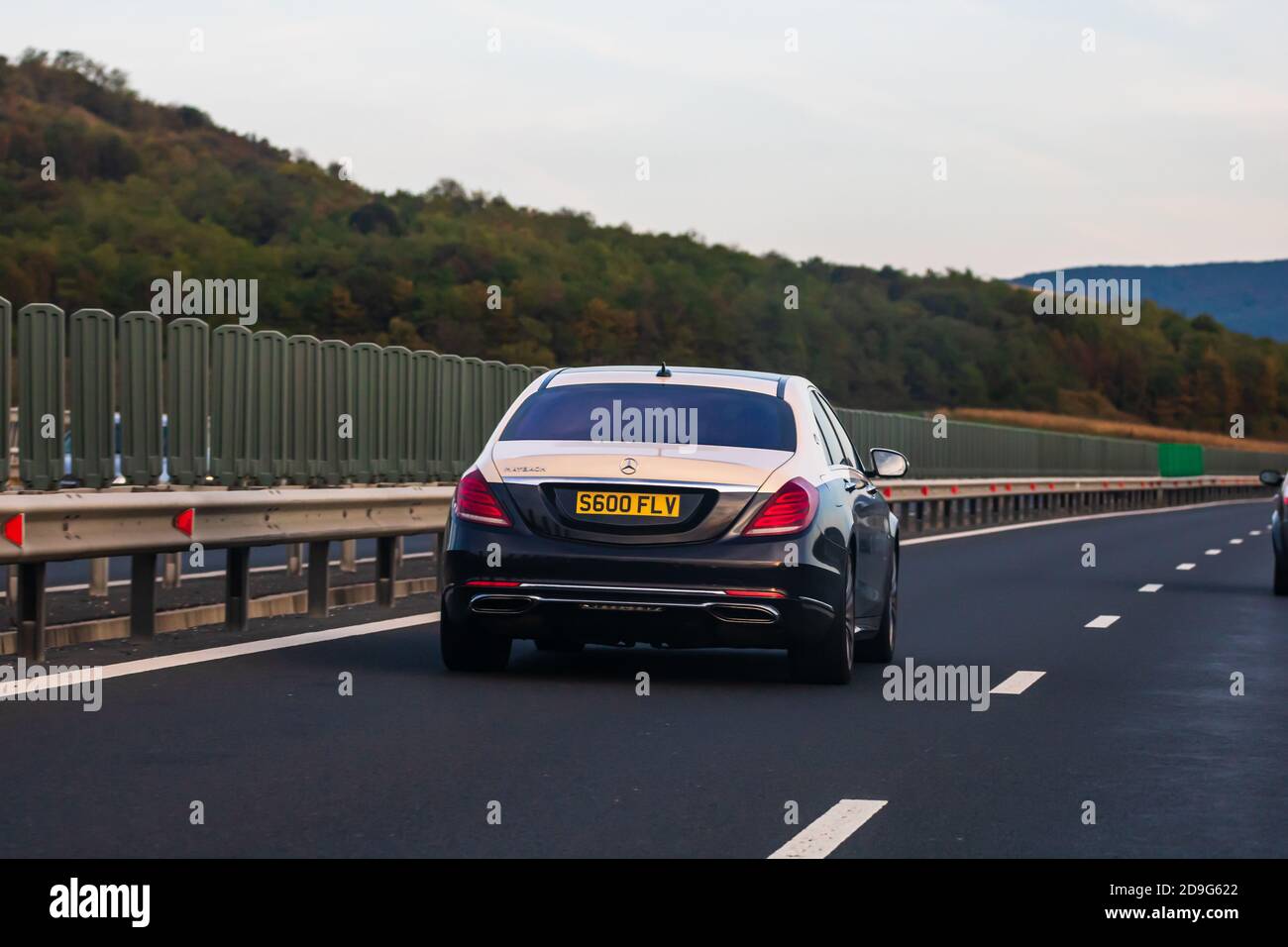 Traveling Mercedes car in motion on asphalt road, back view of car on ...