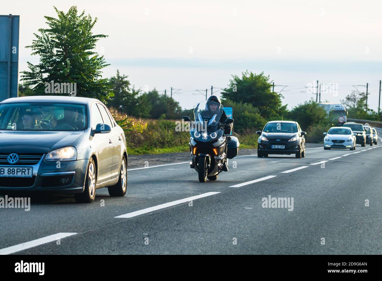 Traveling motorcycle in motion on asphalt road, front view of ...