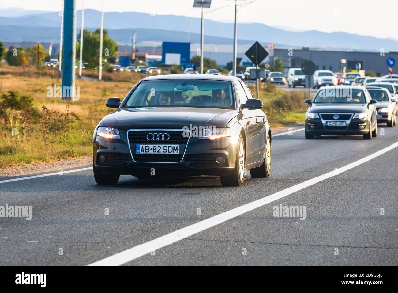Traveling cars in motion on asphalt road, front view of cars in row on ...