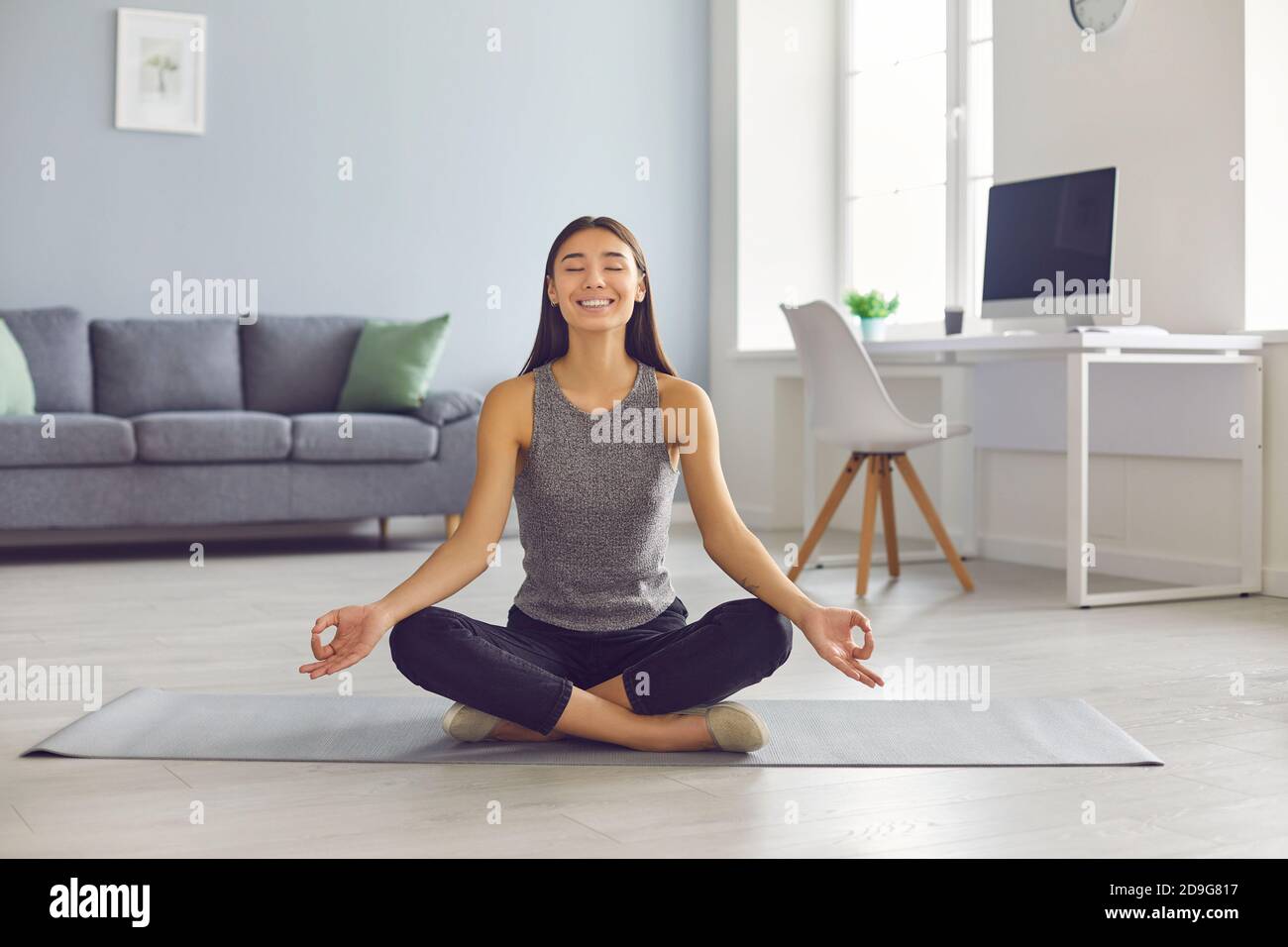 Happy young woman taking break from work in her home office and ...