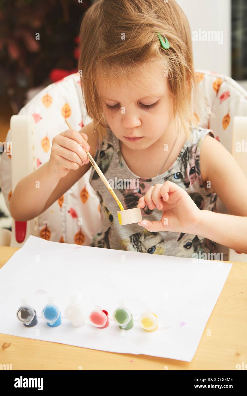 Child Painting. Happy preschool age girl holding a brush painting with ...