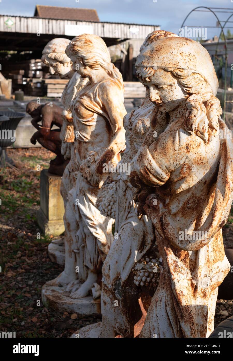 Statue amidst other ephemera at reclamation yard in Wells, Somerset UK ...