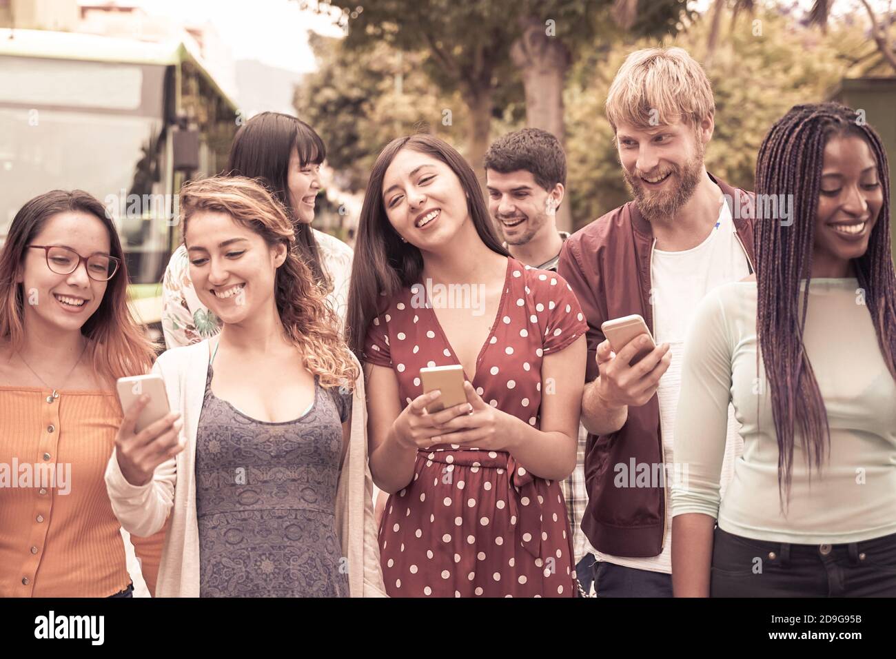 Happy friends using smartphones. Young students people having fun with ...