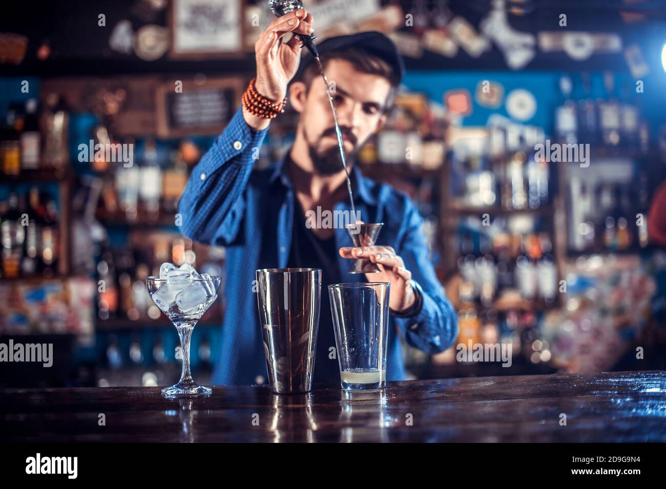 Barman formulates a cocktail behind the bar Stock Photo - Alamy
