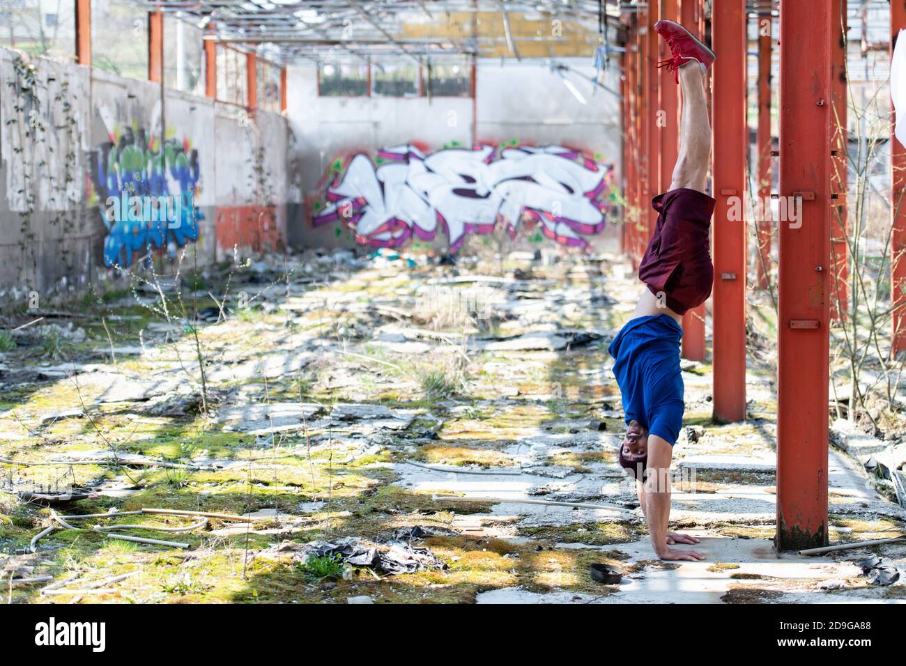 Handsome Man Standing on Hands Strong and Keeping Balance in Warehouse ...