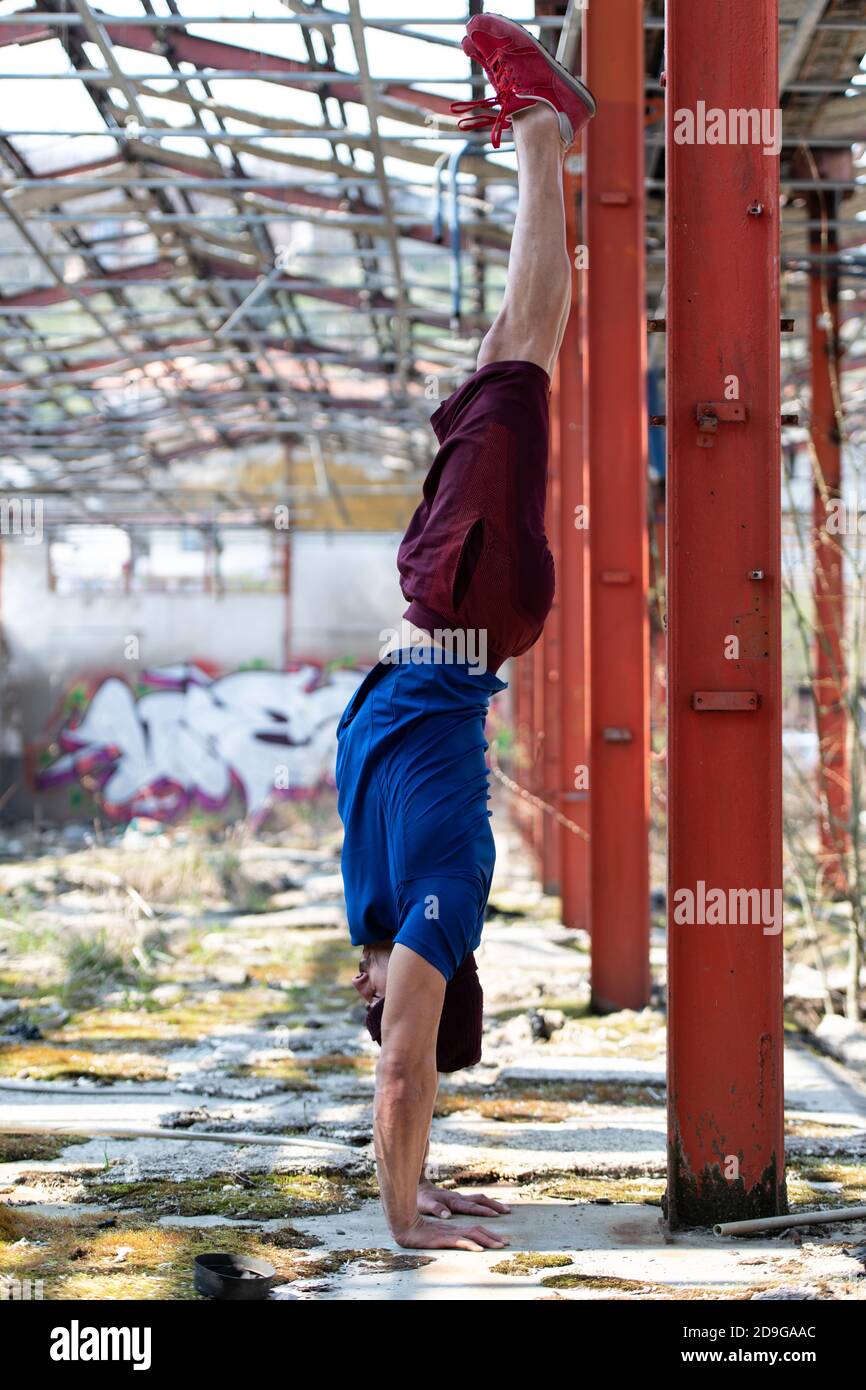 Handsome Man Standing on Hands Strong and Keeping Balance in Warehouse ...