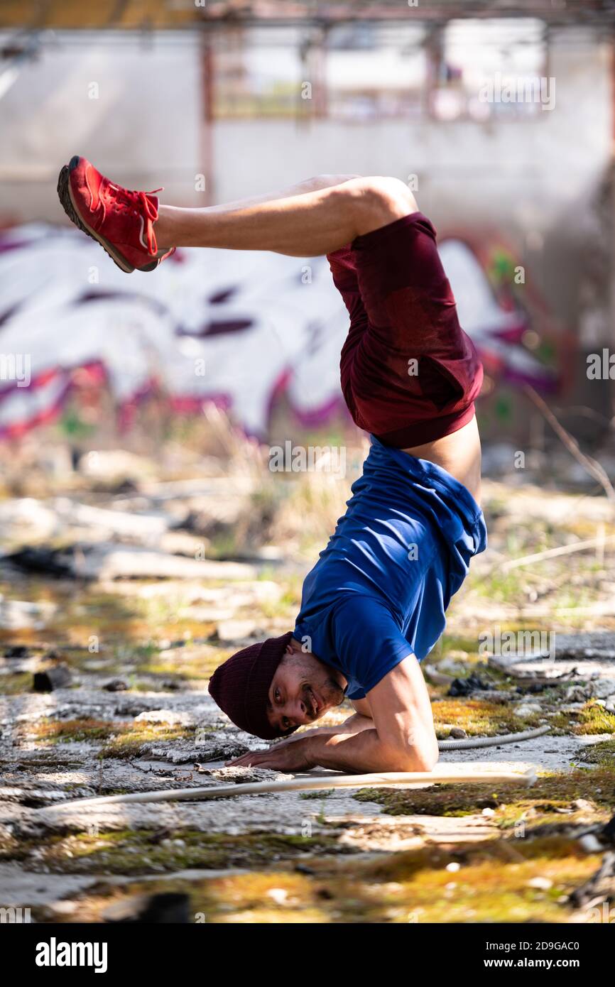Handsome Man Standing on Hands Strong and Keeping Balance in Warehouse ...