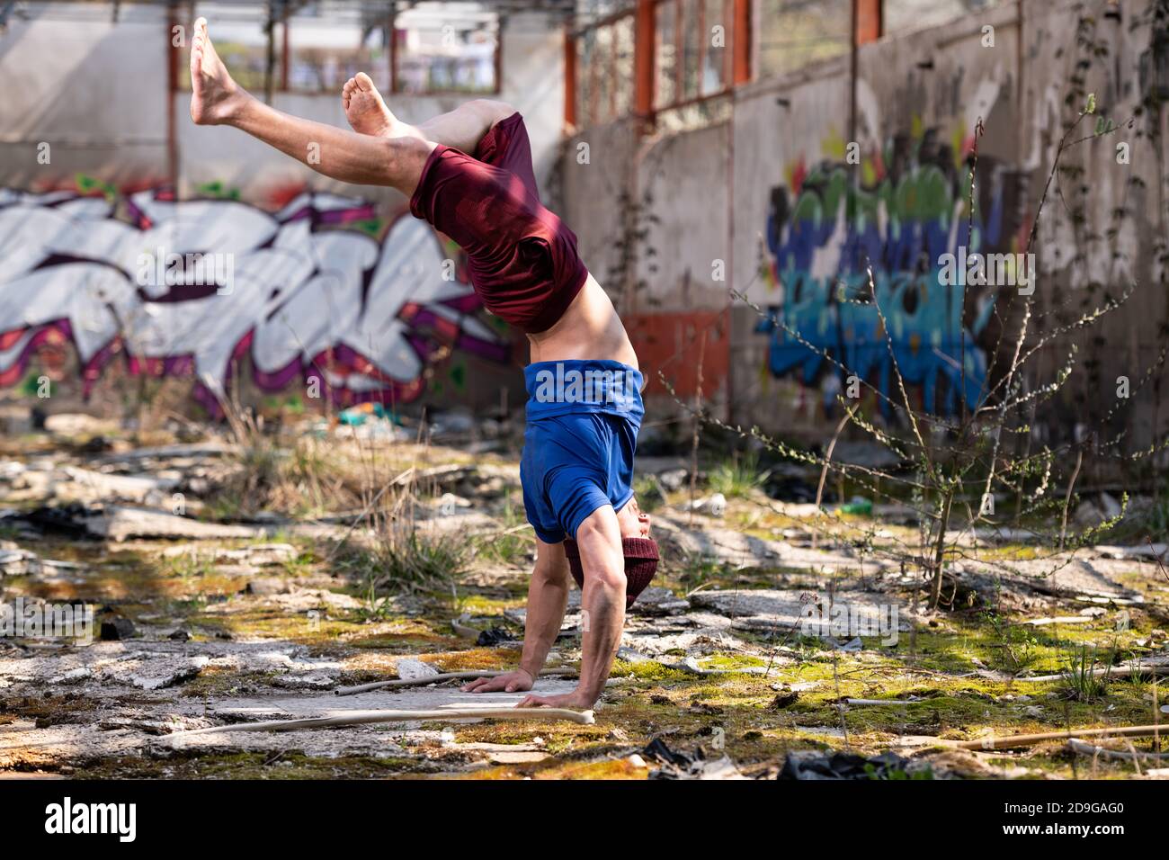 Young Man Standing on Hands Strong and Keeping Balance in Warehouse ...