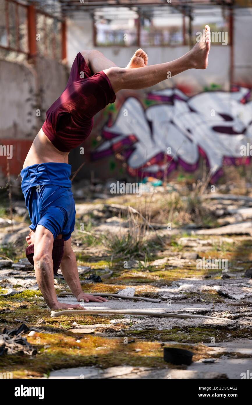 Handsome Man Standing on Hands Strong and Keeping Balance in Warehouse ...