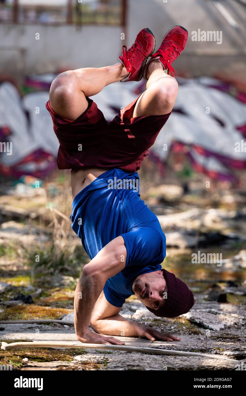 Handsome Man Standing on Hands Strong and Keeping Balance in Warehouse ...