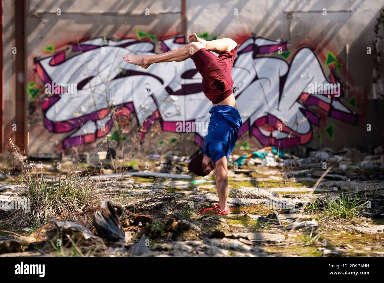 Handsome Man Standing on Hands Strong and Keeping Balance in Warehouse ...
