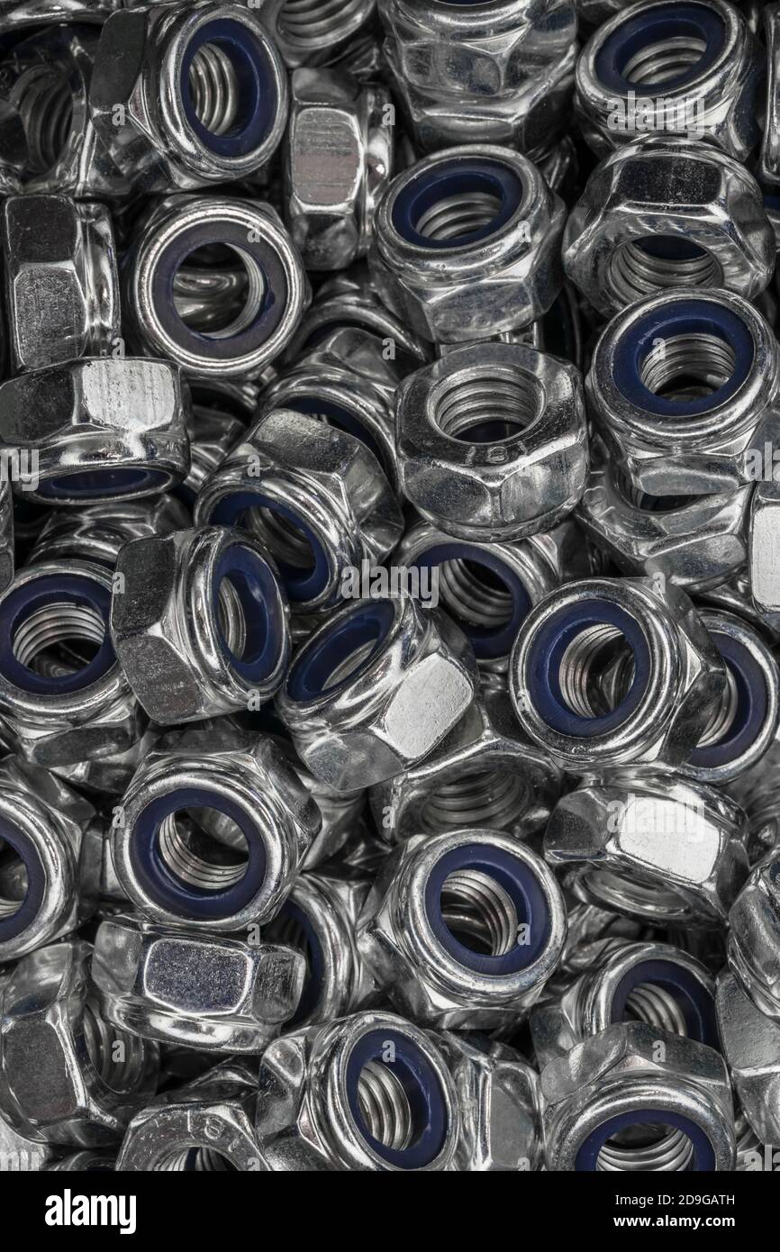 pattern of zinc plated screw nuts Stock Photo - Alamy