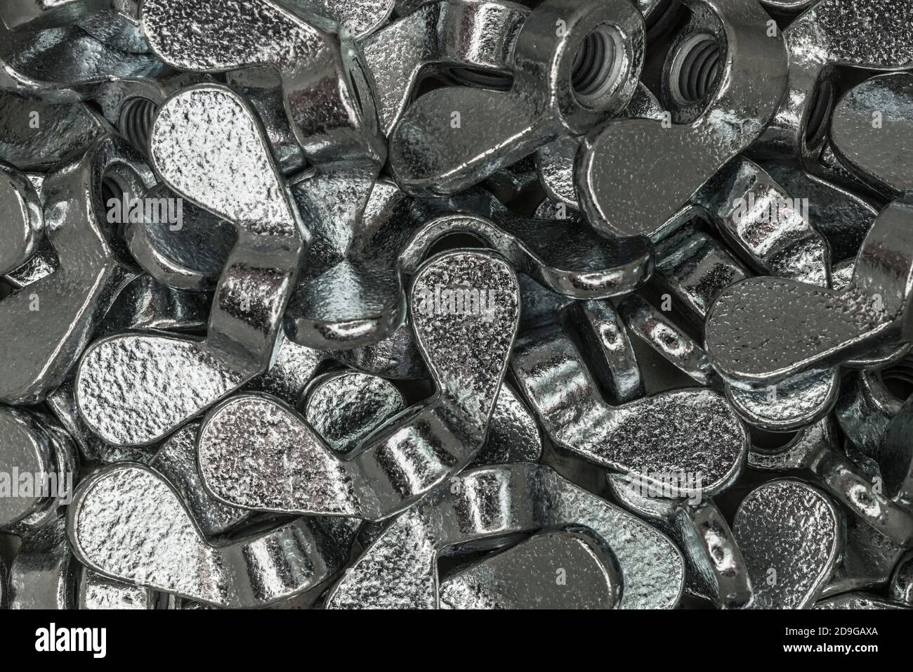 pattern of zinc plated screw nuts Stock Photo - Alamy