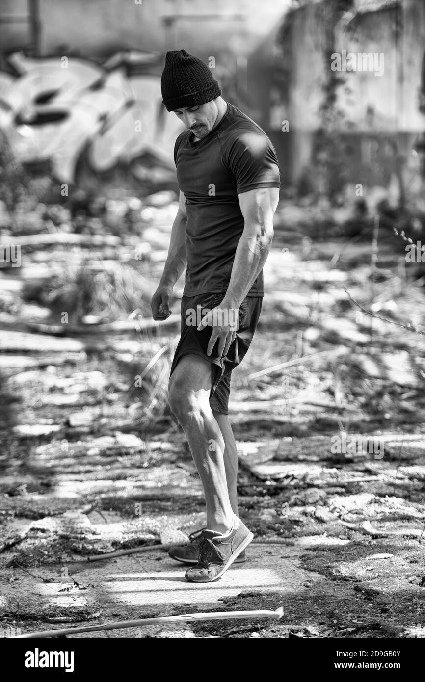 Portrait of a Young Physically Fit Man Standing In Warehouse Showing ...