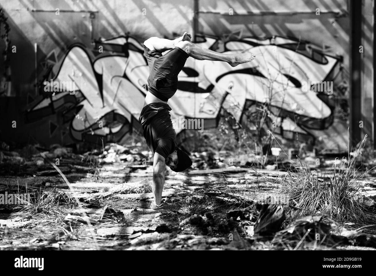 Handsome Man Standing on Hands Strong and Keeping Balance in Warehouse ...