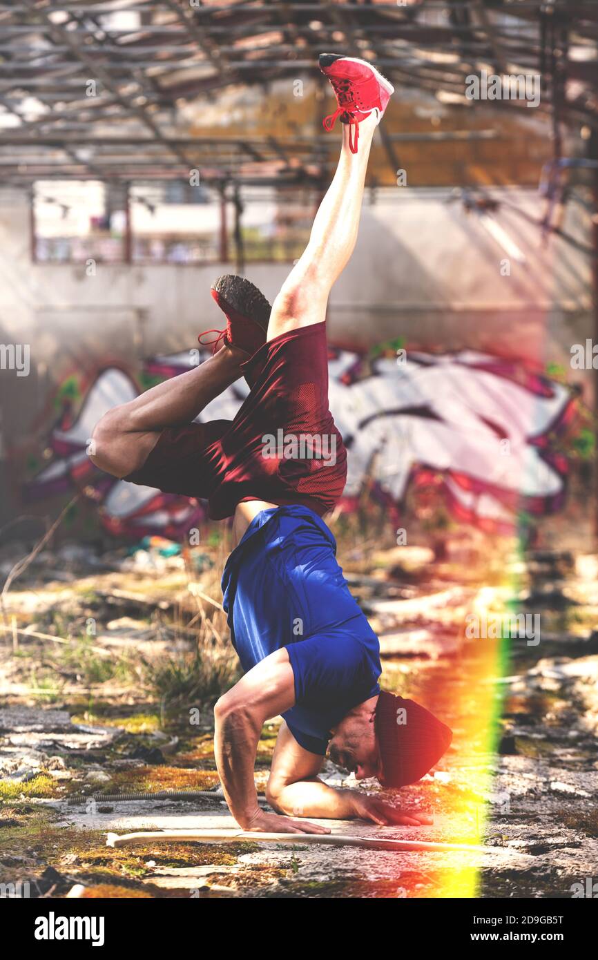 Young Man Standing on Hands Strong and Keeping Balance in Warehouse ...