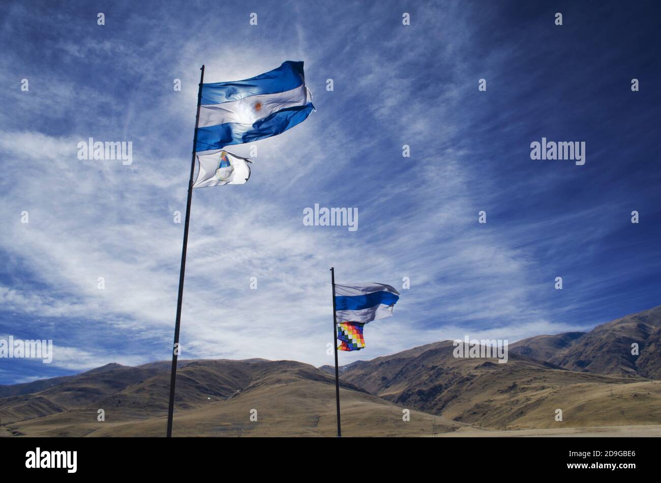 Low angle shot of the flag of Argentina with small native peoples flags ...