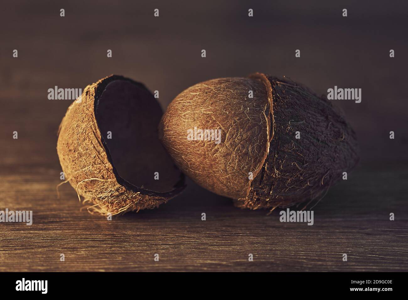 Closeup shot of a broken coconut on the wooden table Stock Photo - Alamy