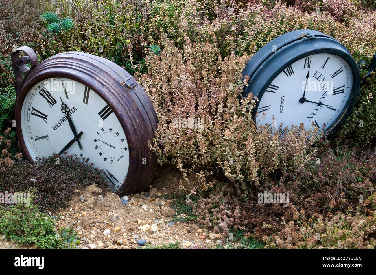 Giant Clocks In A Bed Of Flowers Stock Photo - Alamy