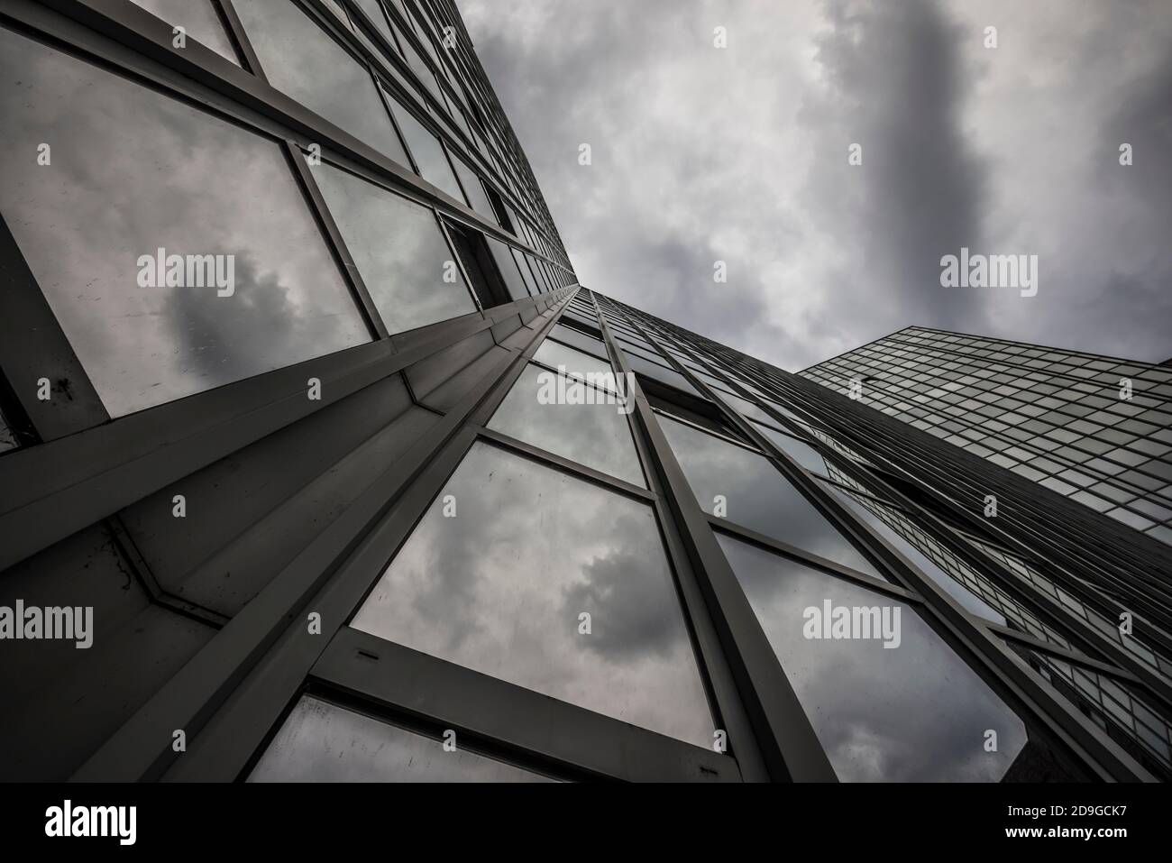 storm clouds in the facade of a modern high rise building Stock Photo ...