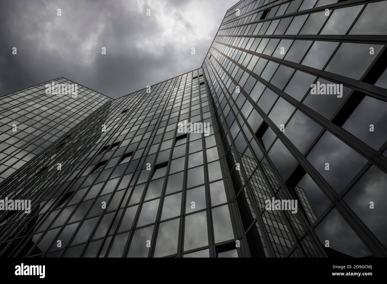 storm clouds in the facade of a modern high rise building Stock Photo ...