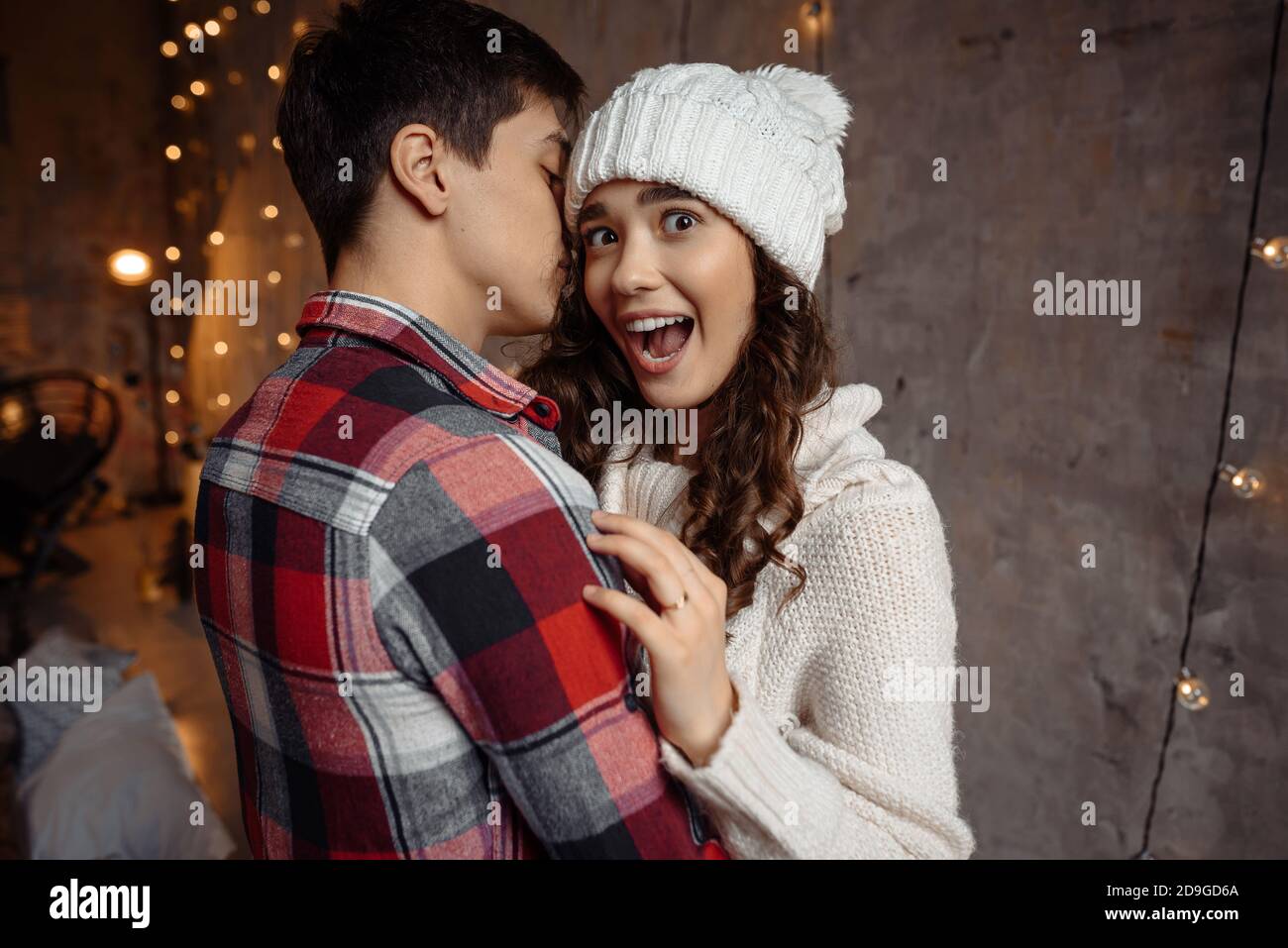 Portrait of two happy people in love wearing winter clothes, having fun ...