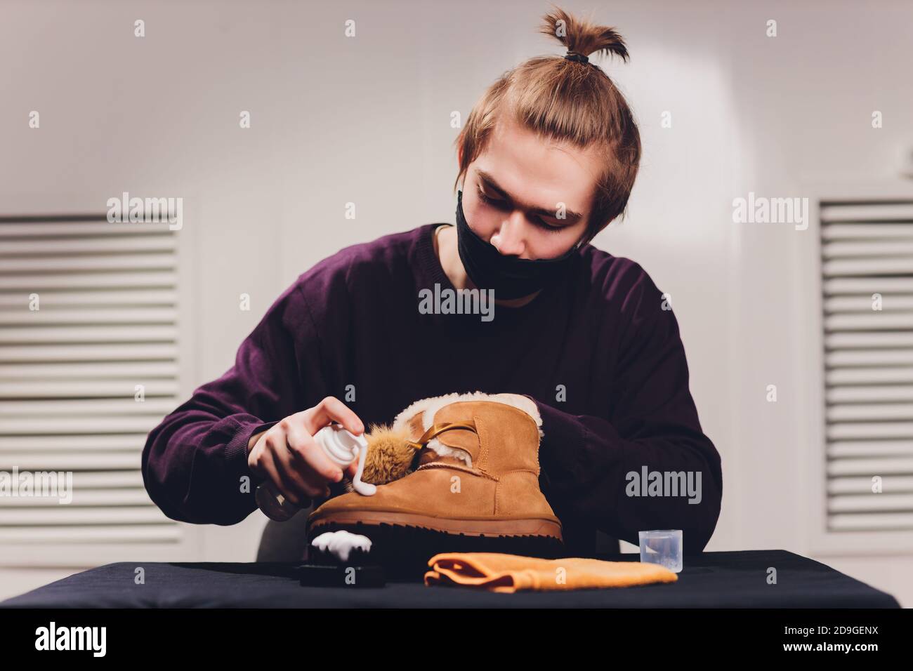 Hands cleaning men's camel suede desert shoe boot with a brush ...
