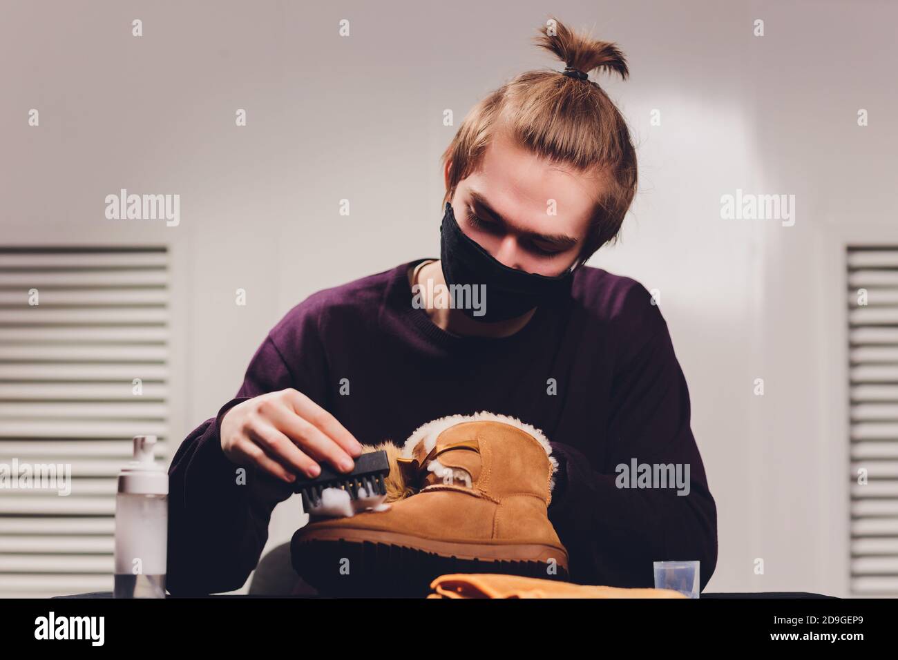 Hands cleaning men's camel suede desert shoe boot with a brush ...