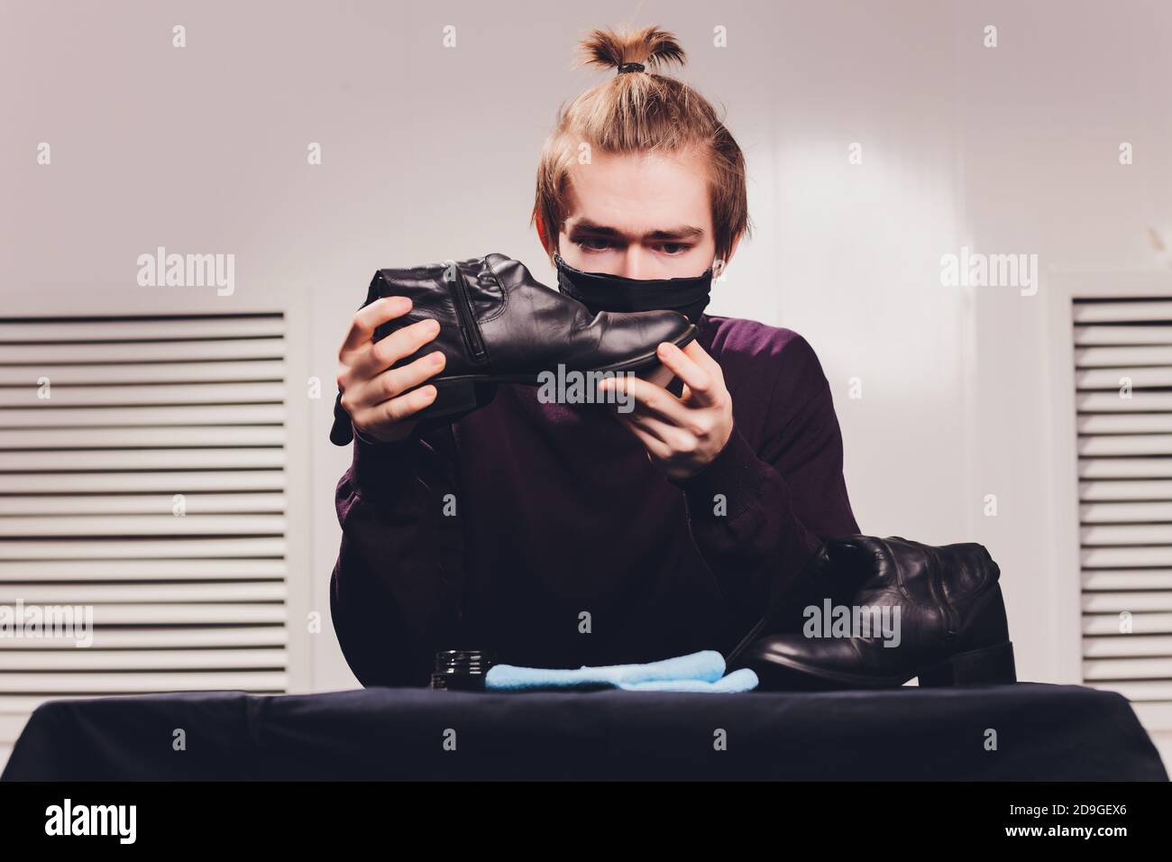 boots. applying cream with your finger. Shoe repair Stock Photo - Alamy